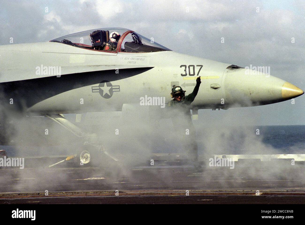 Smoke drifts up from a catapult as an F/A-18 Hornet aircraft from ...