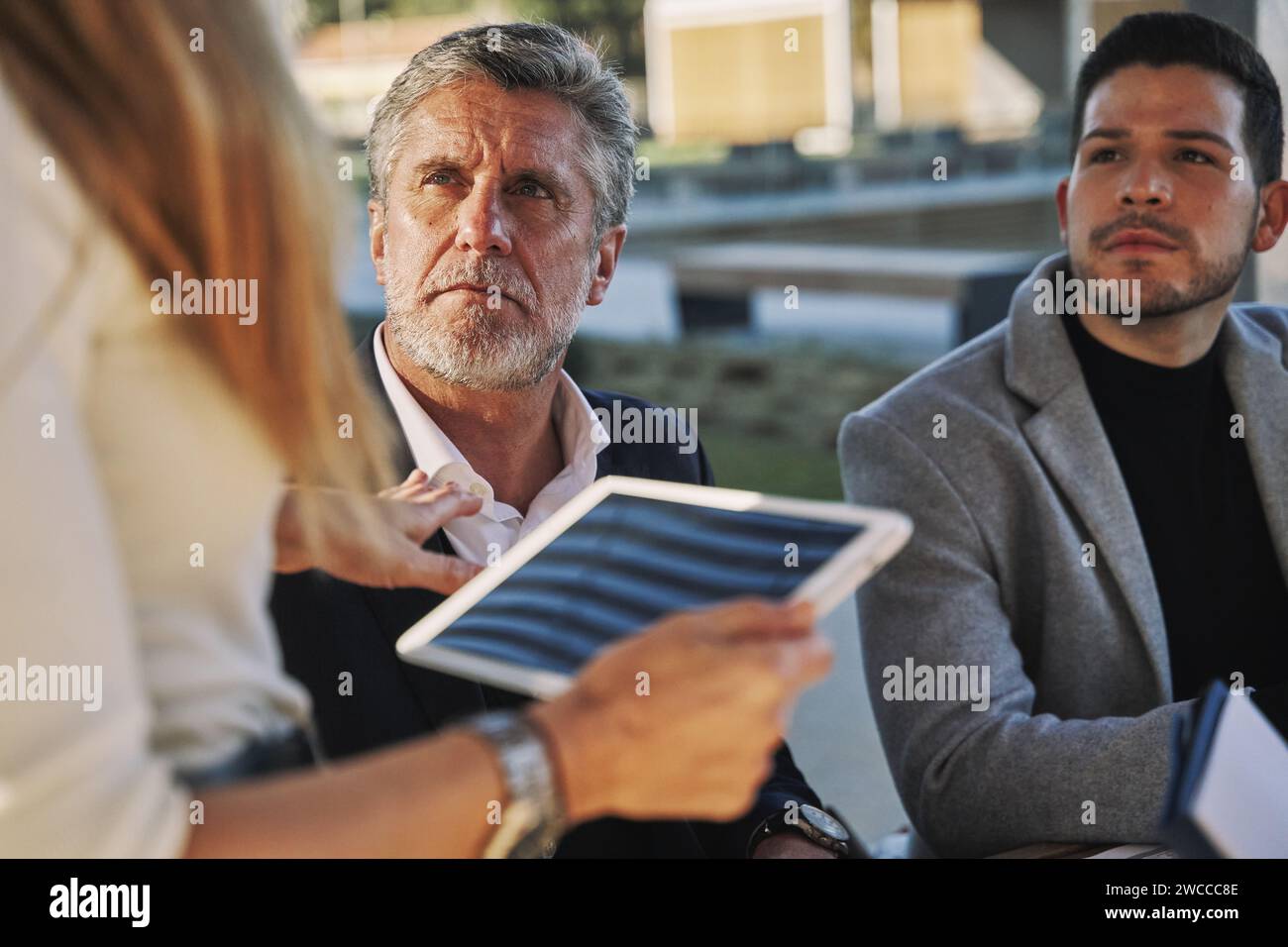 Creative team working. Back view of business woman with tablet pc ...