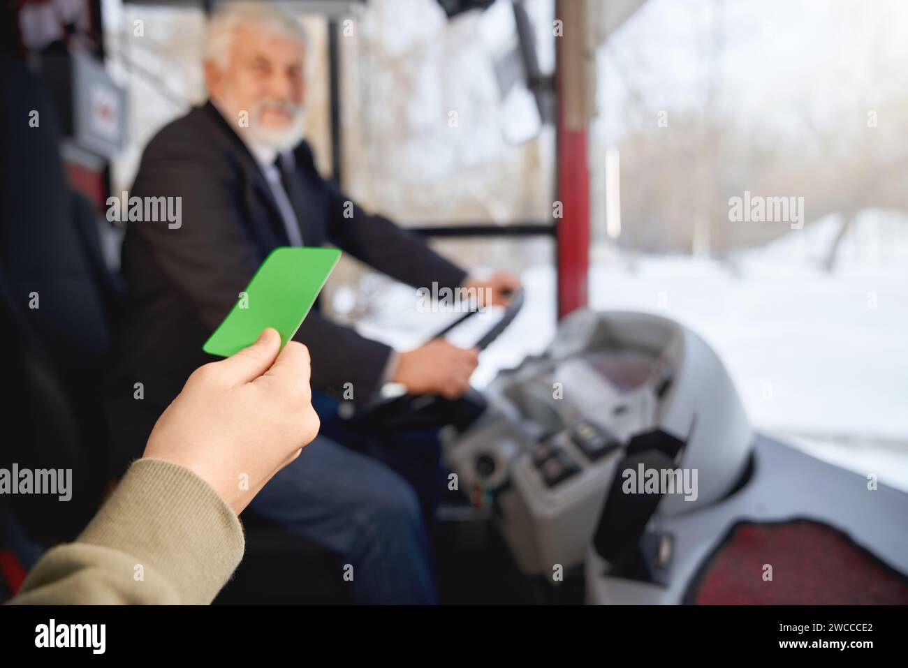 Close up view of hand holding green payment card showing to driver ...