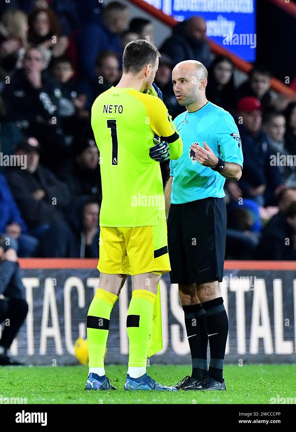 Neto of AFC Bournemouth talks to referee Simon Hooper as Tom Lockyer of ...