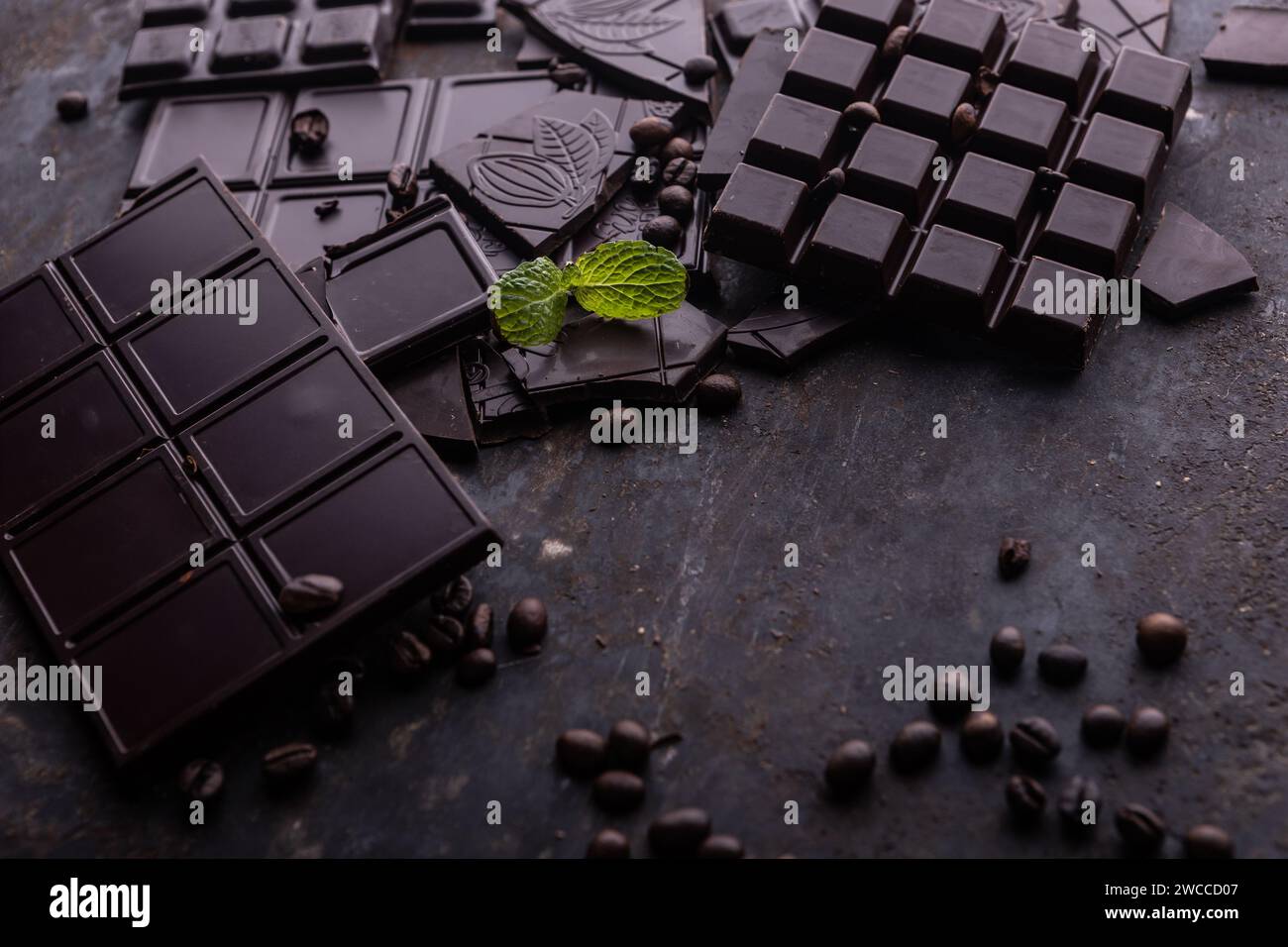 Crushed chocolate on a rustic background. Different types of chocolate ...