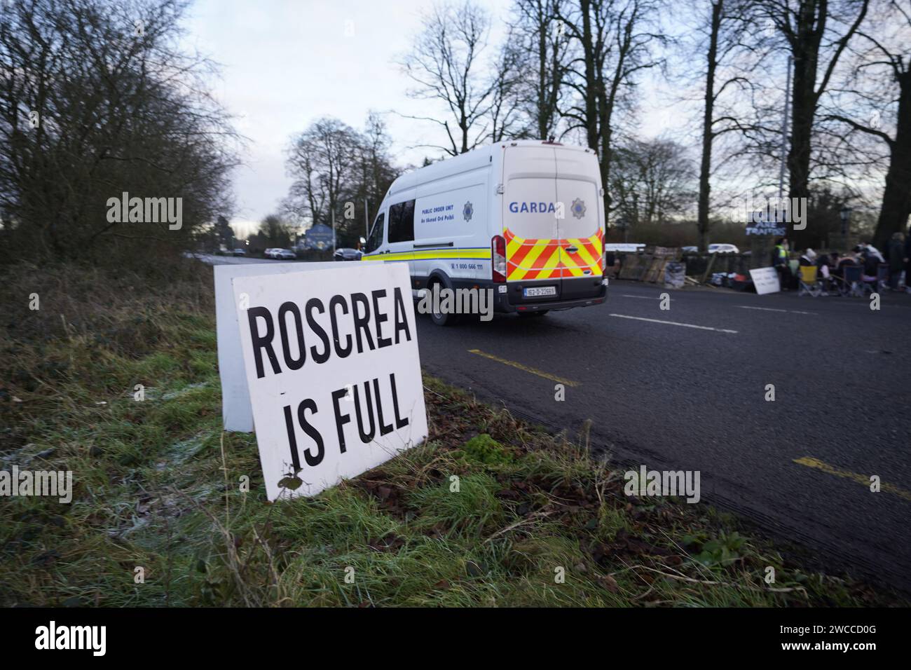 A Garda van passes protesters at the Racket Hall hotel in Roscrea, Co ...