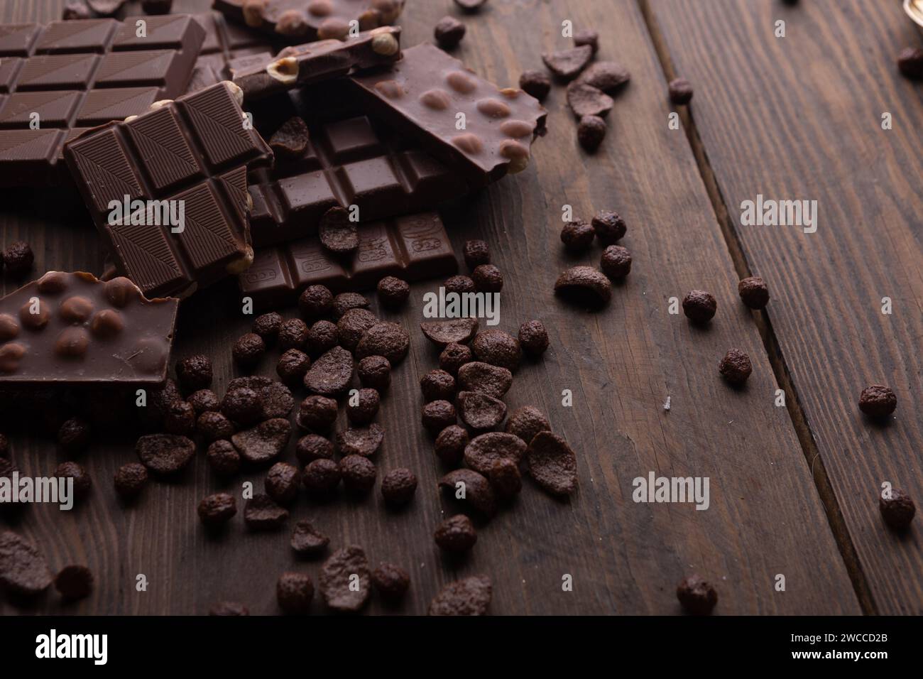 Crushed chocolate on a rustic background. Different types of chocolate ...