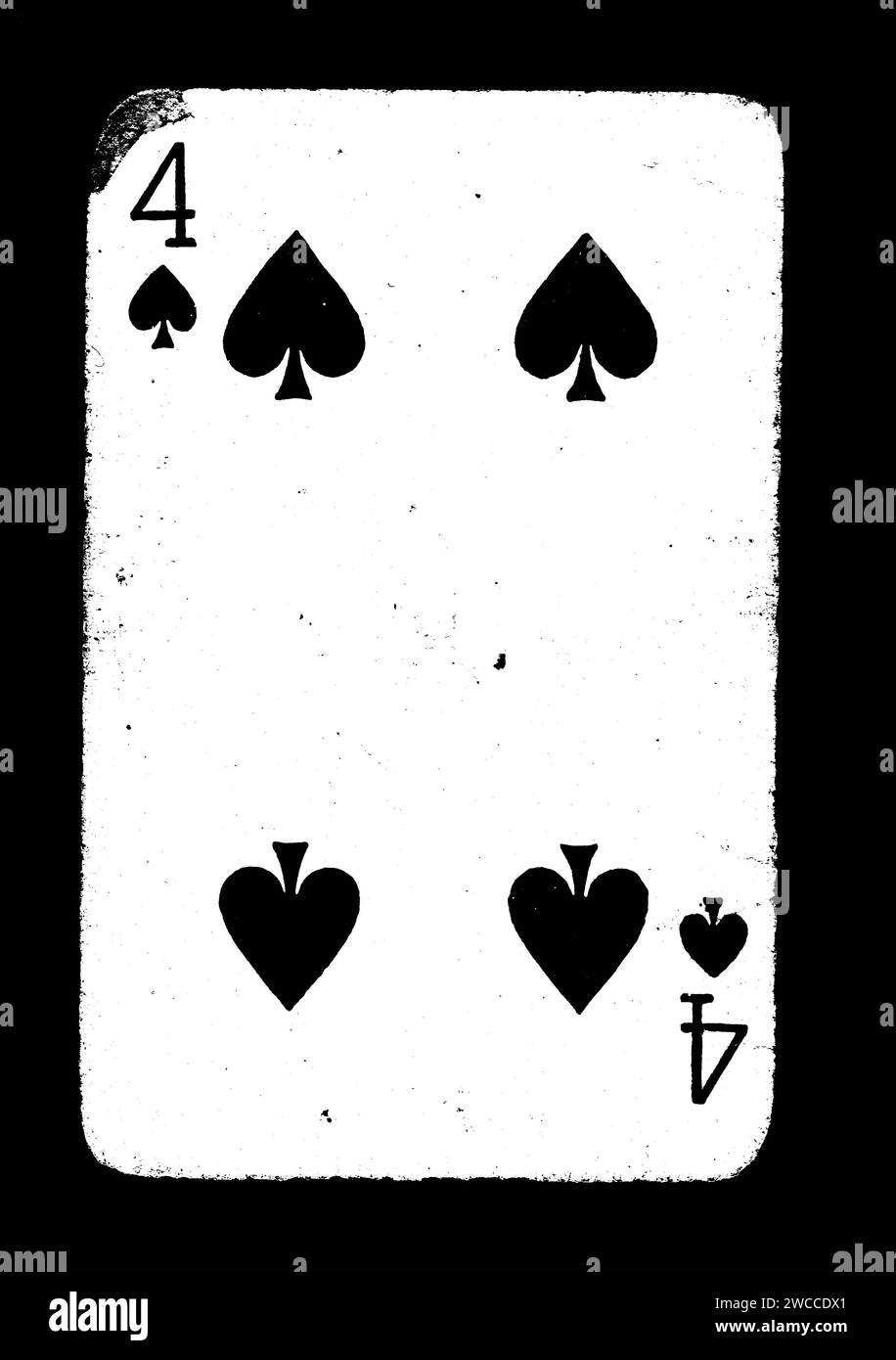 A vintage four of spades playing card isolated on a black background ...