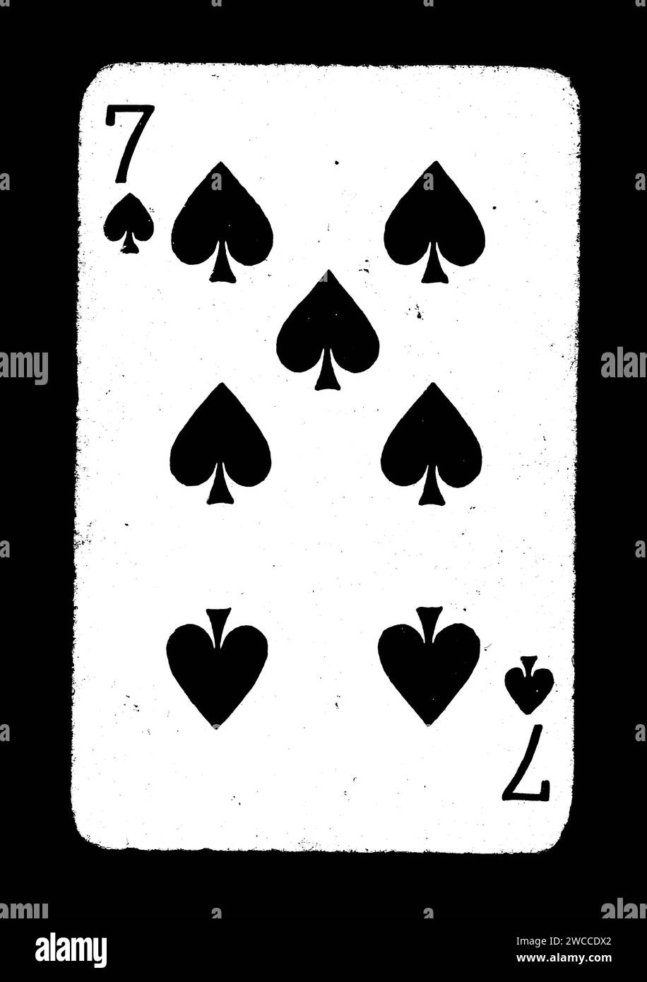A vintage seven of spades playing card isolated on a black background ...