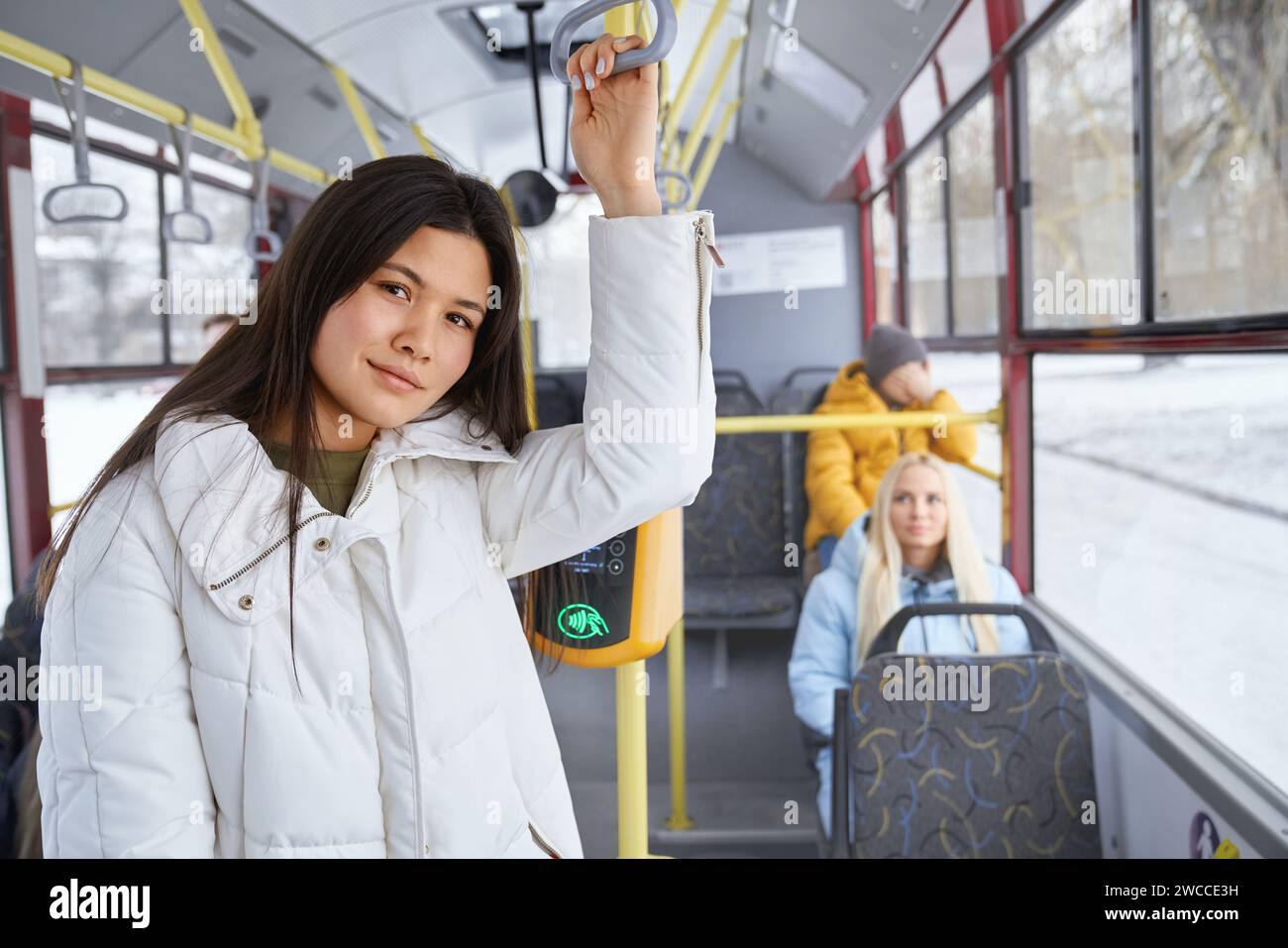 Portrait of brunette young female holding handle standing tilting head ...