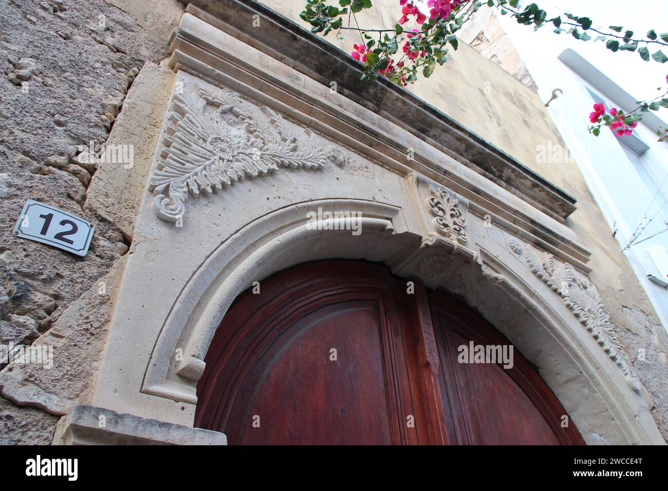 old gate with wood door and sculpted stone arc in rethymno in crete in ...