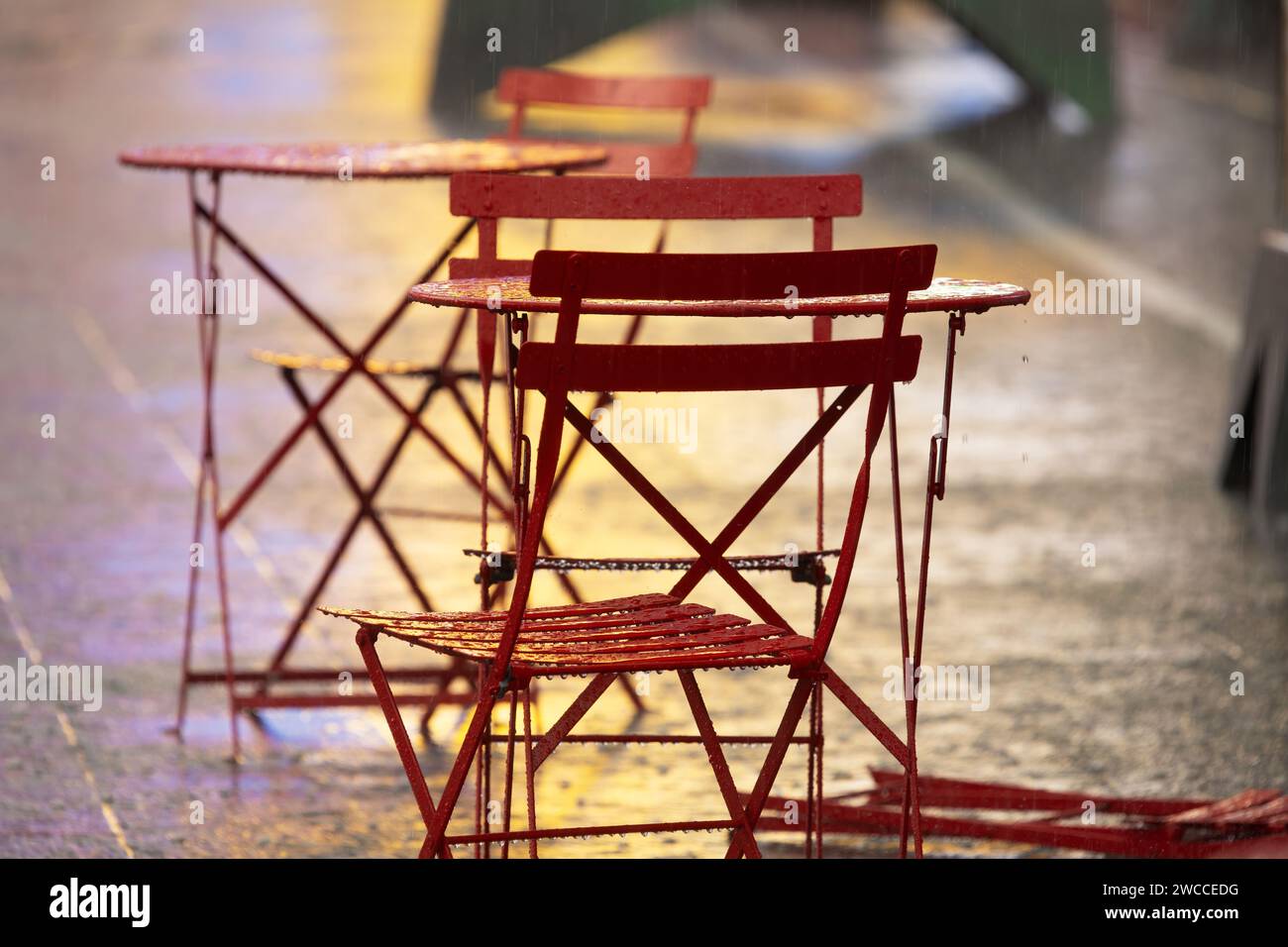 Cafe chairs, heavy rain at Times Square Stock Photo - Alamy