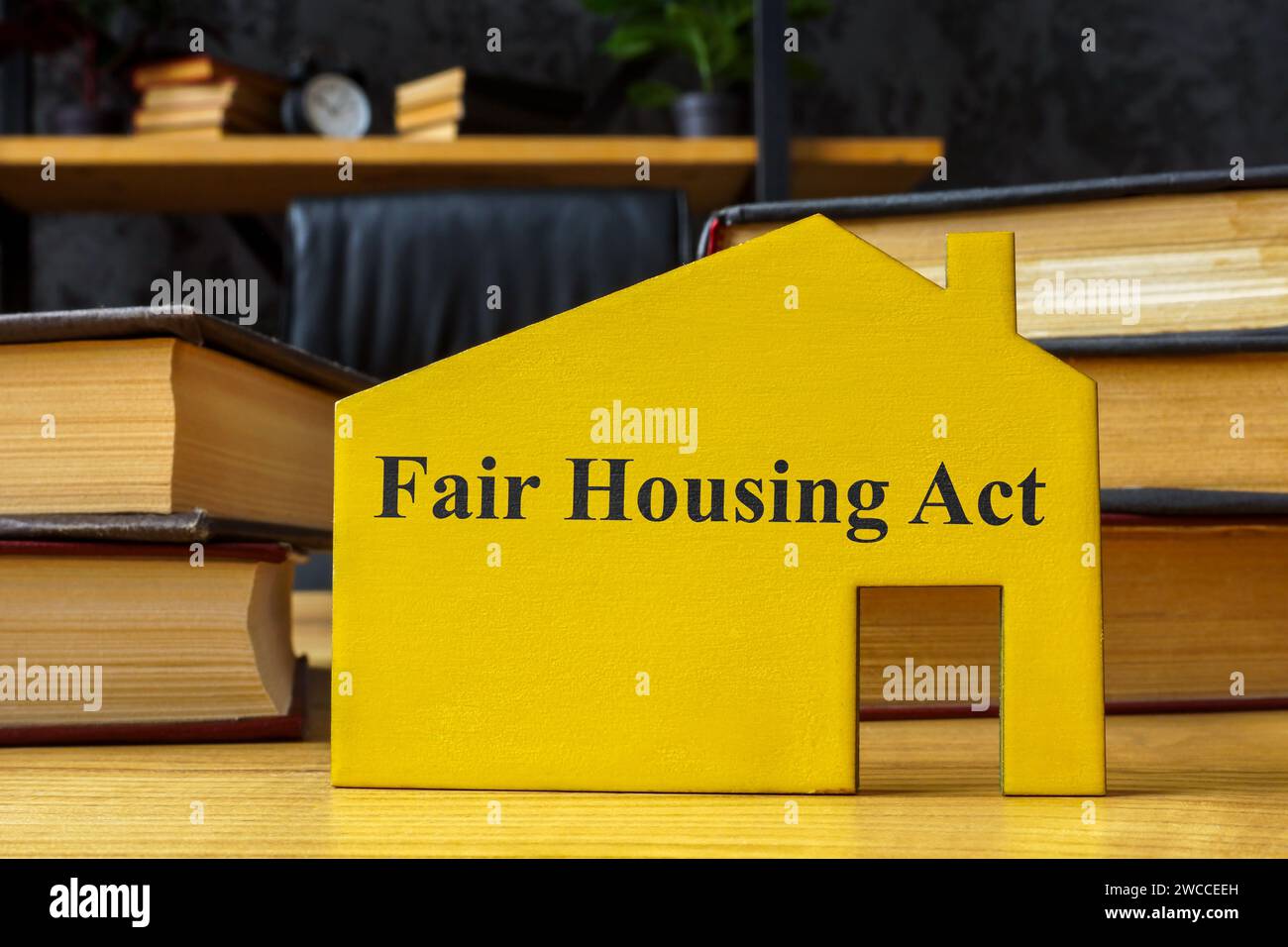 FHA fair housing act concept. Wooden model of a house with an ...