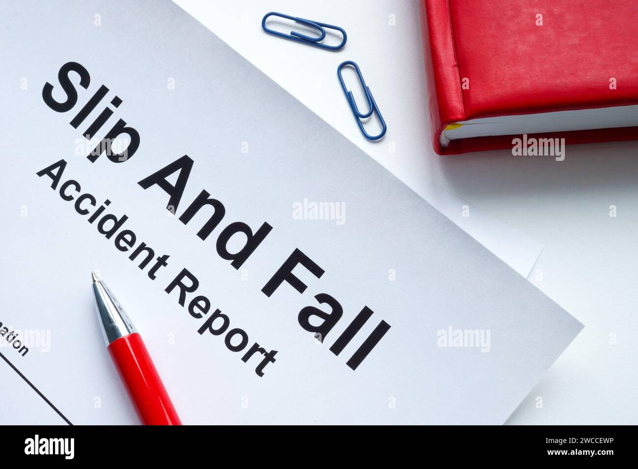Slip and fall accident report and notepad Stock Photo - Alamy
