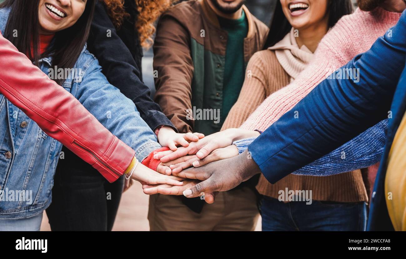 Happy group of people stacking hands together. Friends team celebrating ...