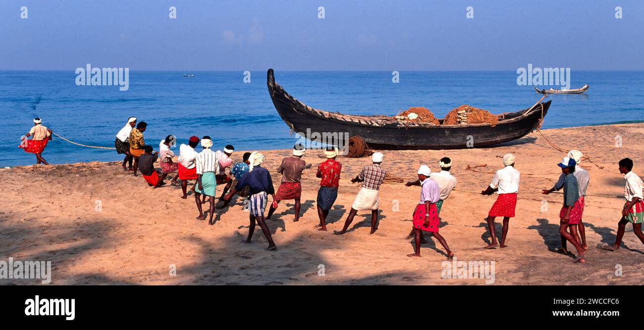 Fishing boats seine nets and a long line of colourful fishermen hauling ...