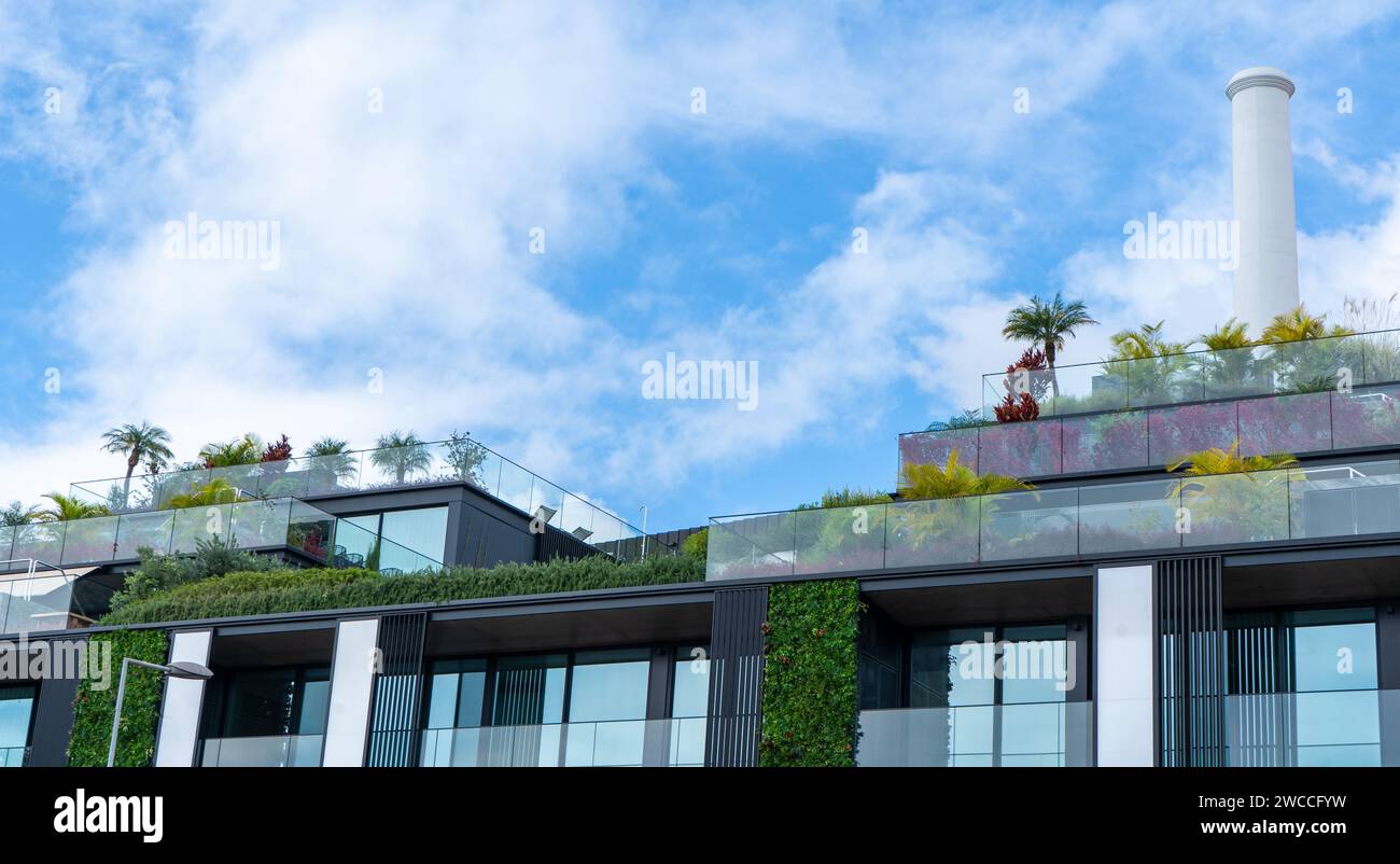 Green building design with large green walls and outdoor urban balcony ...