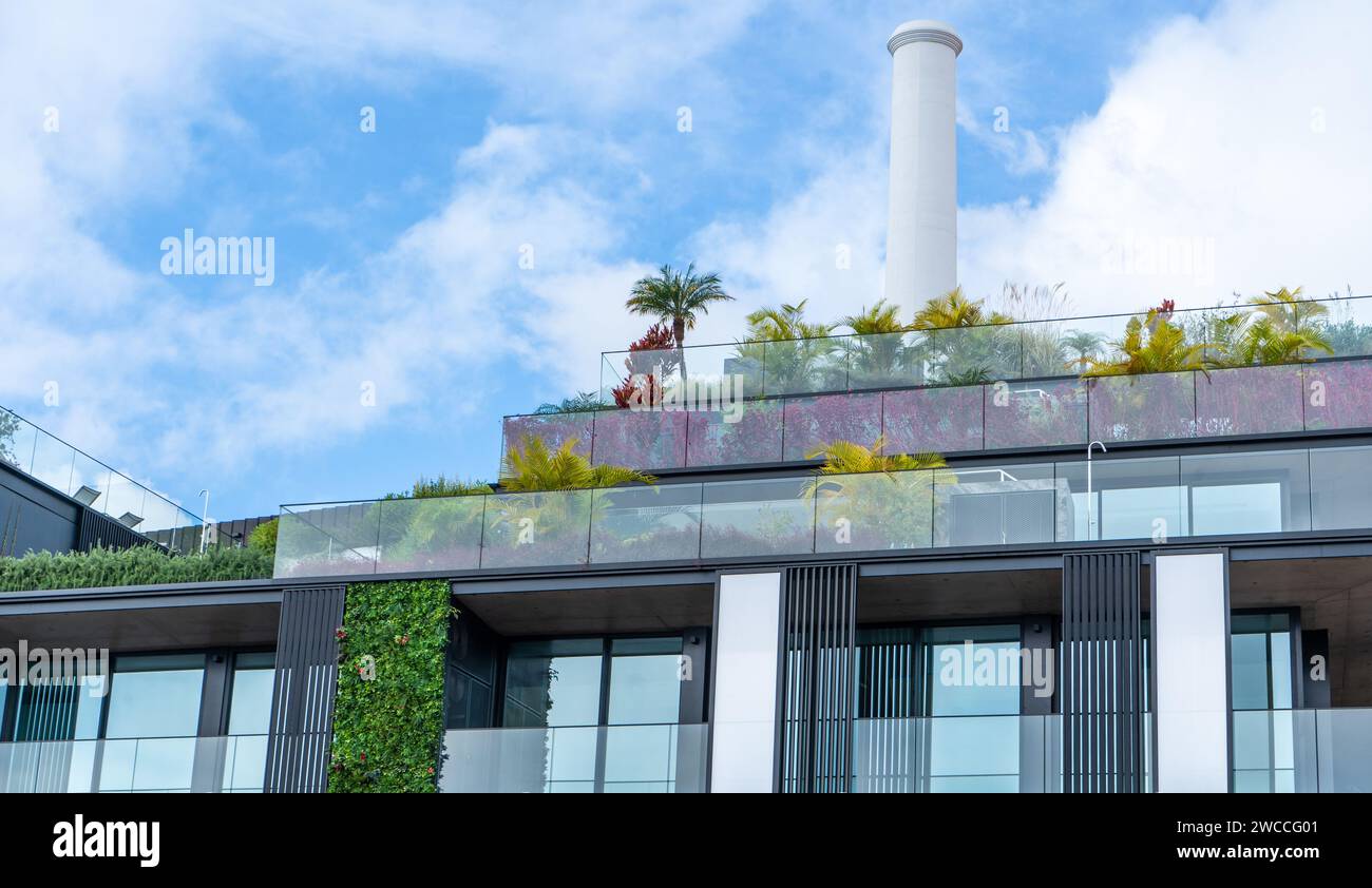 Green building design with large green walls and outdoor urban balcony ...