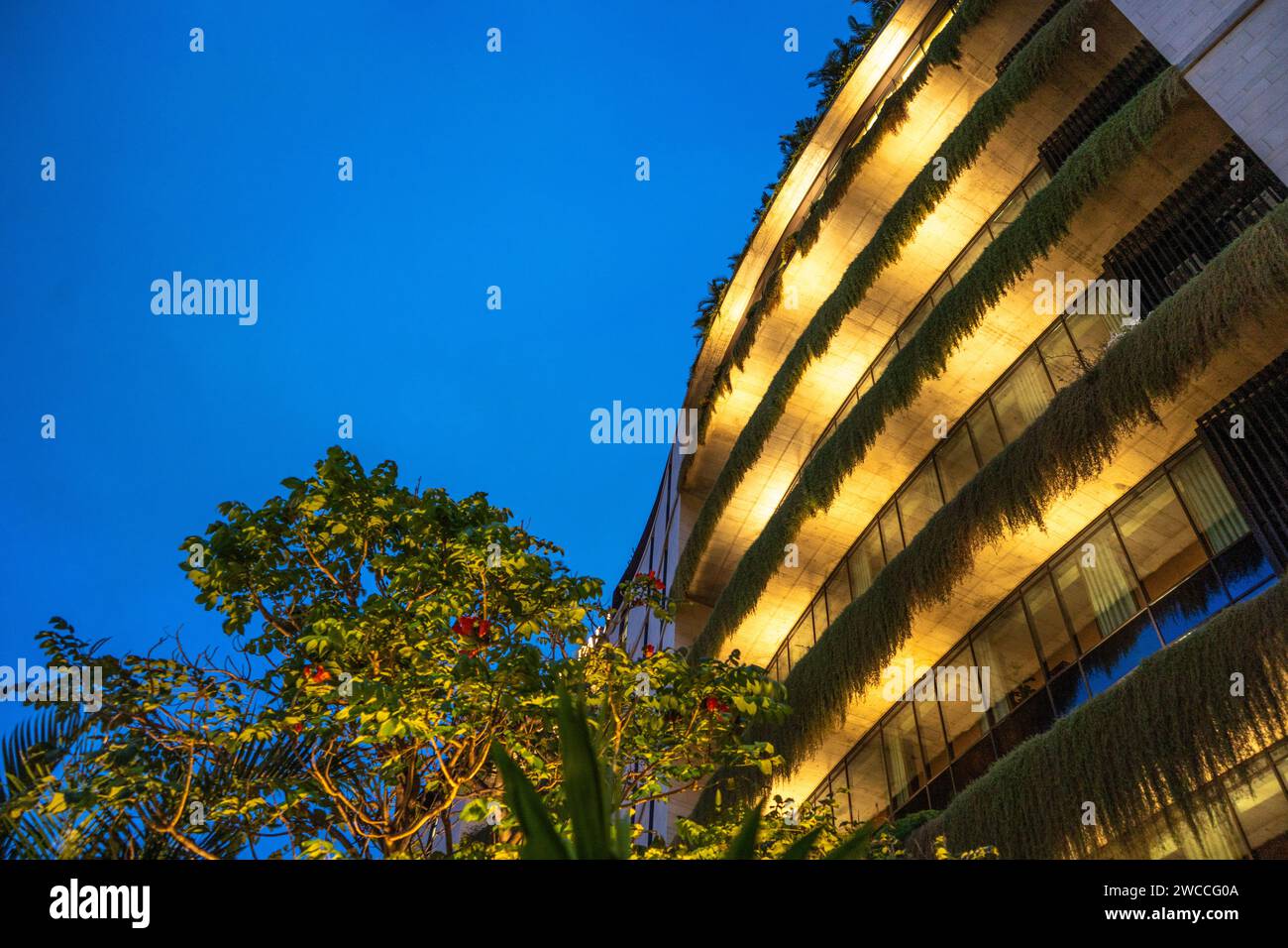 Green building design with large green walls and outdoor urban balcony ...