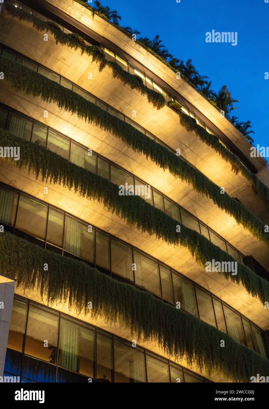 Green building design with large green walls and outdoor urban balcony ...