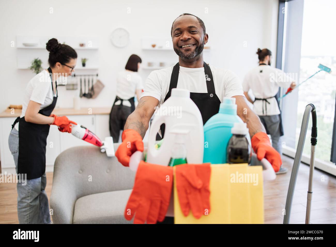 African man professional cleaning worker holding a bucket with ...