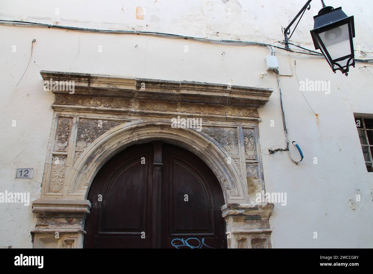 old gate with wood door and sculpted stone arc in rethymno in crete in ...