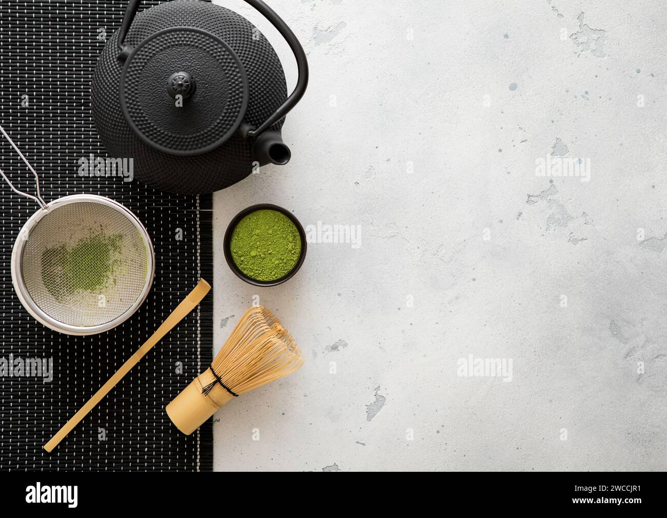 Japanese iron kettle with matcha green tea powder with whisk and spoon ...