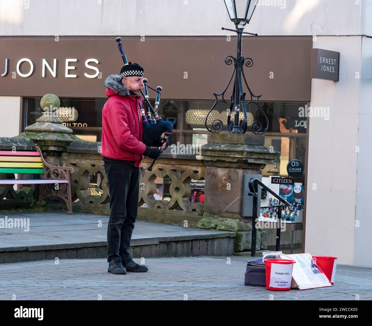 Street entertainer playing bagpipes on High Bridge, High Street ...