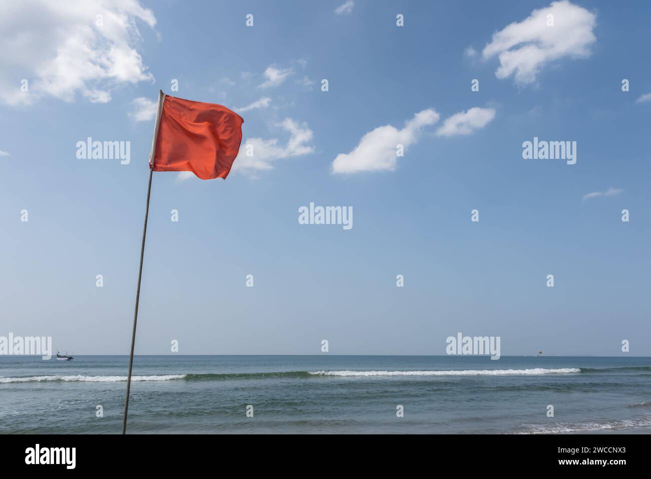 red flag on beach on sea or ocean as a symbol of danger. The sea state ...