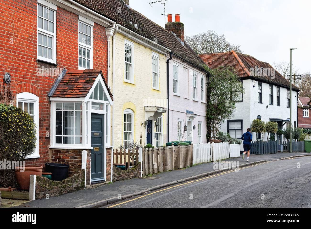 Exteriors of old and attractive terraced cottages painted in pastels ...