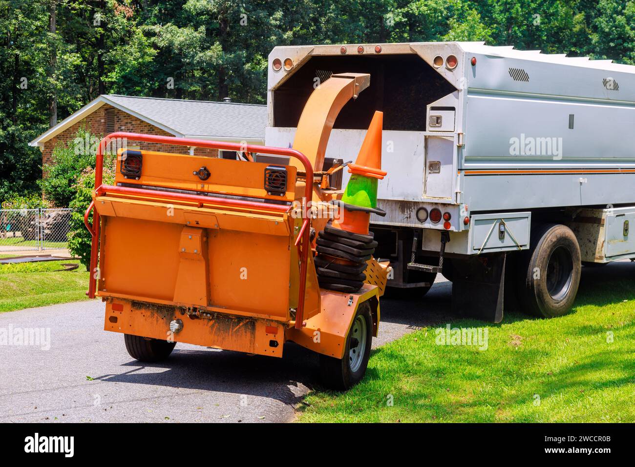 Wood chipper machine releases ground tree branches that are shredded ...