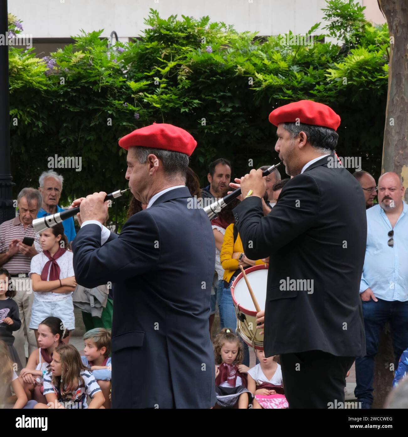 two men wearing Basque Red Beret play dultzaina during the fiesta San ...