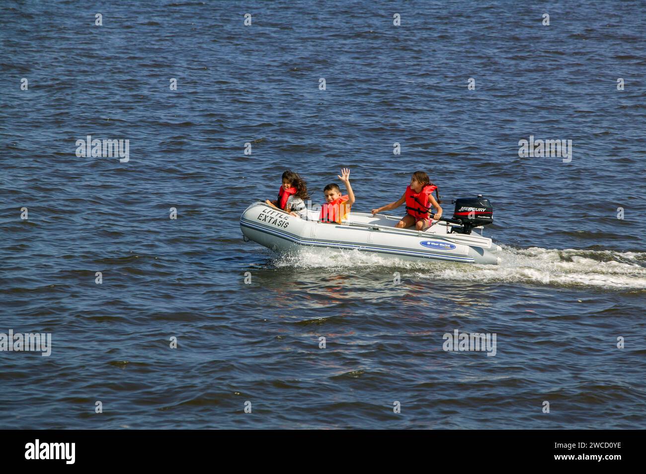 Kids riding in a small motor boat, Florida Stock Photo - Alamy