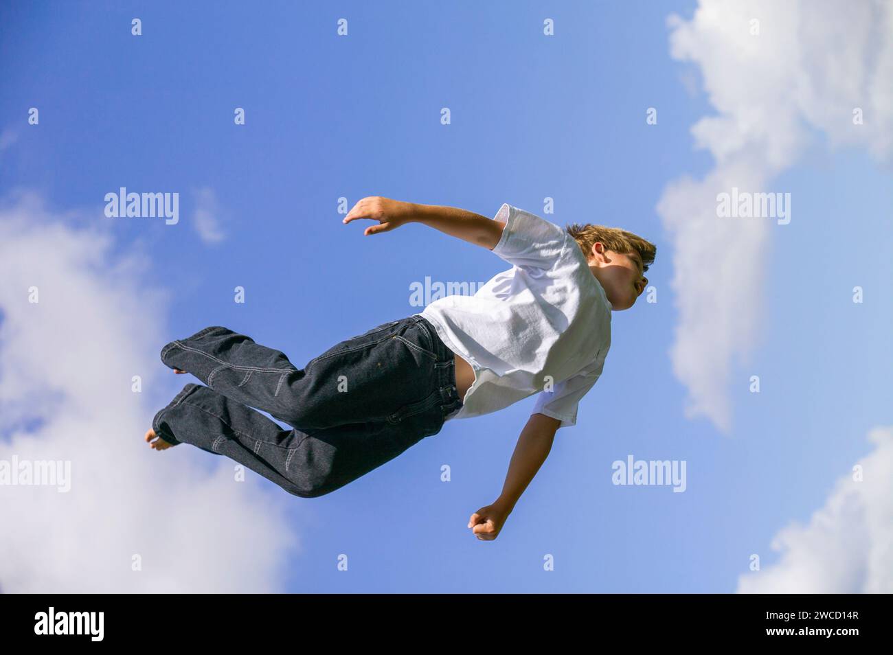 One young boy leaping in the air Stock Photo - Alamy