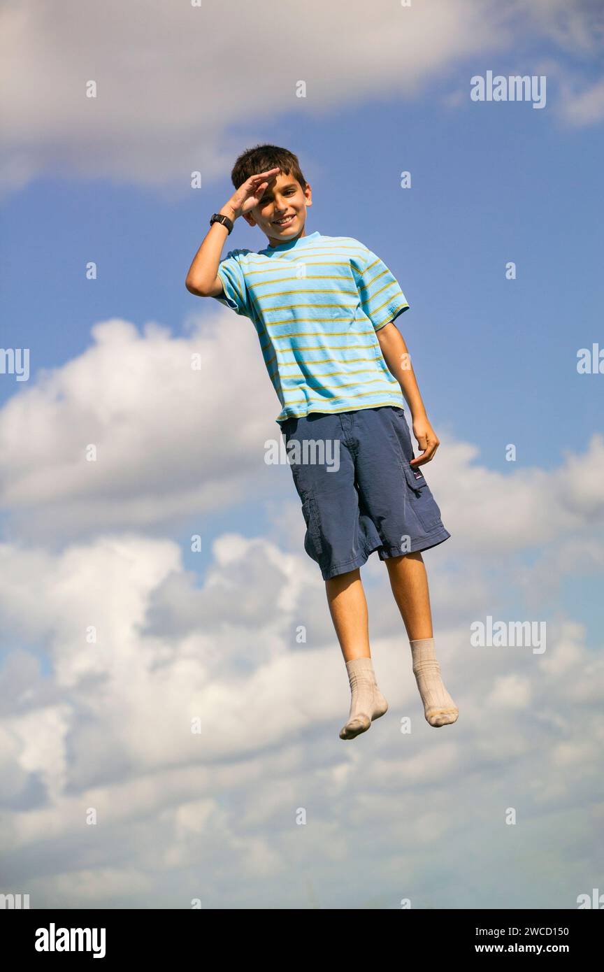 One young boy leaping in the air Stock Photo - Alamy