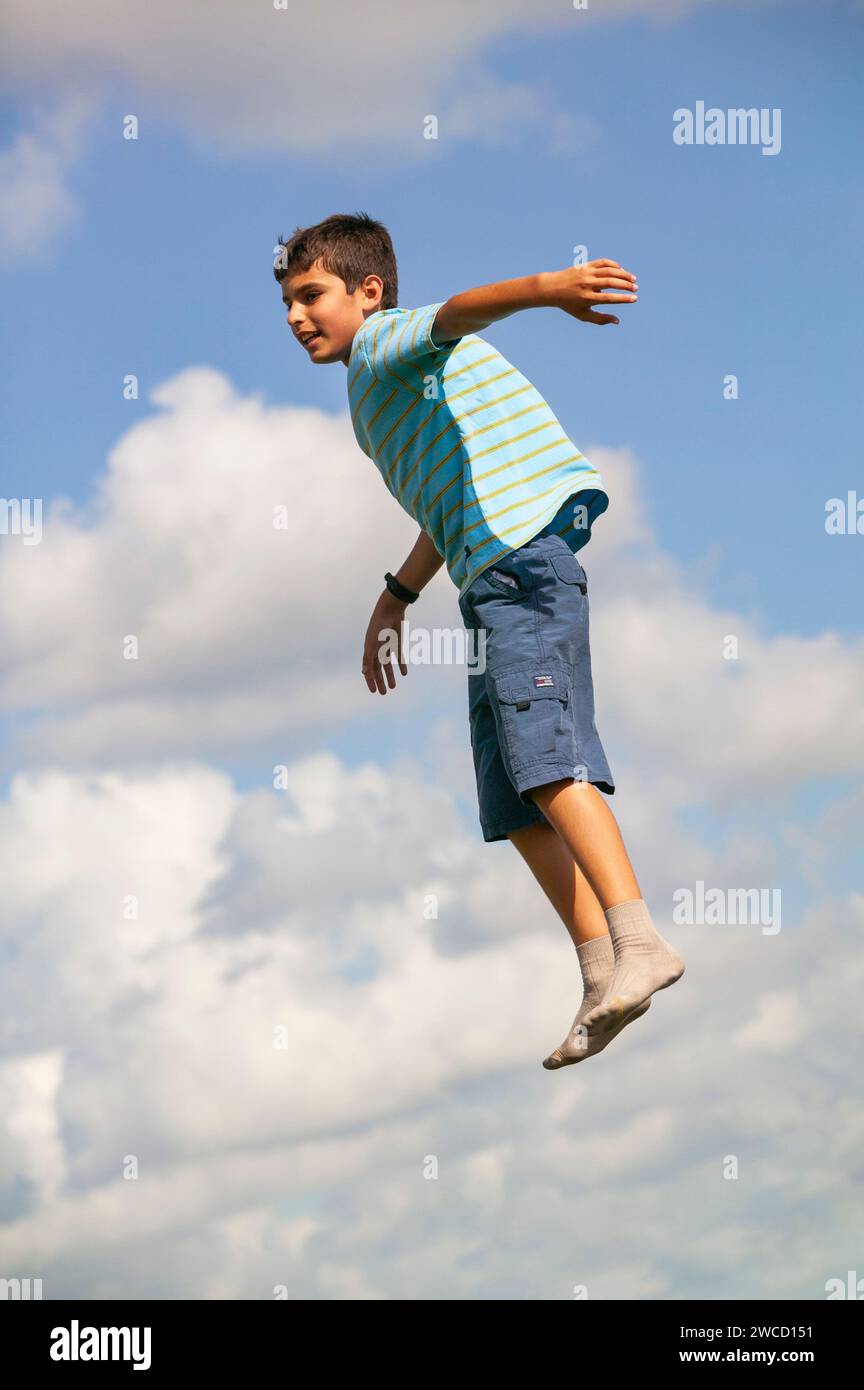 One young boy leaping in the air Stock Photo - Alamy