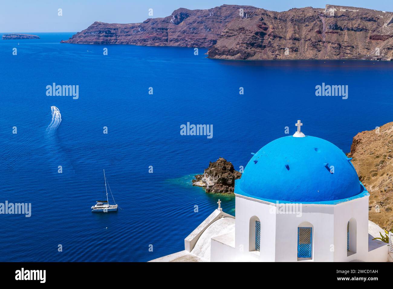 Typical white and blue architecture with domes and churches of Oia ...