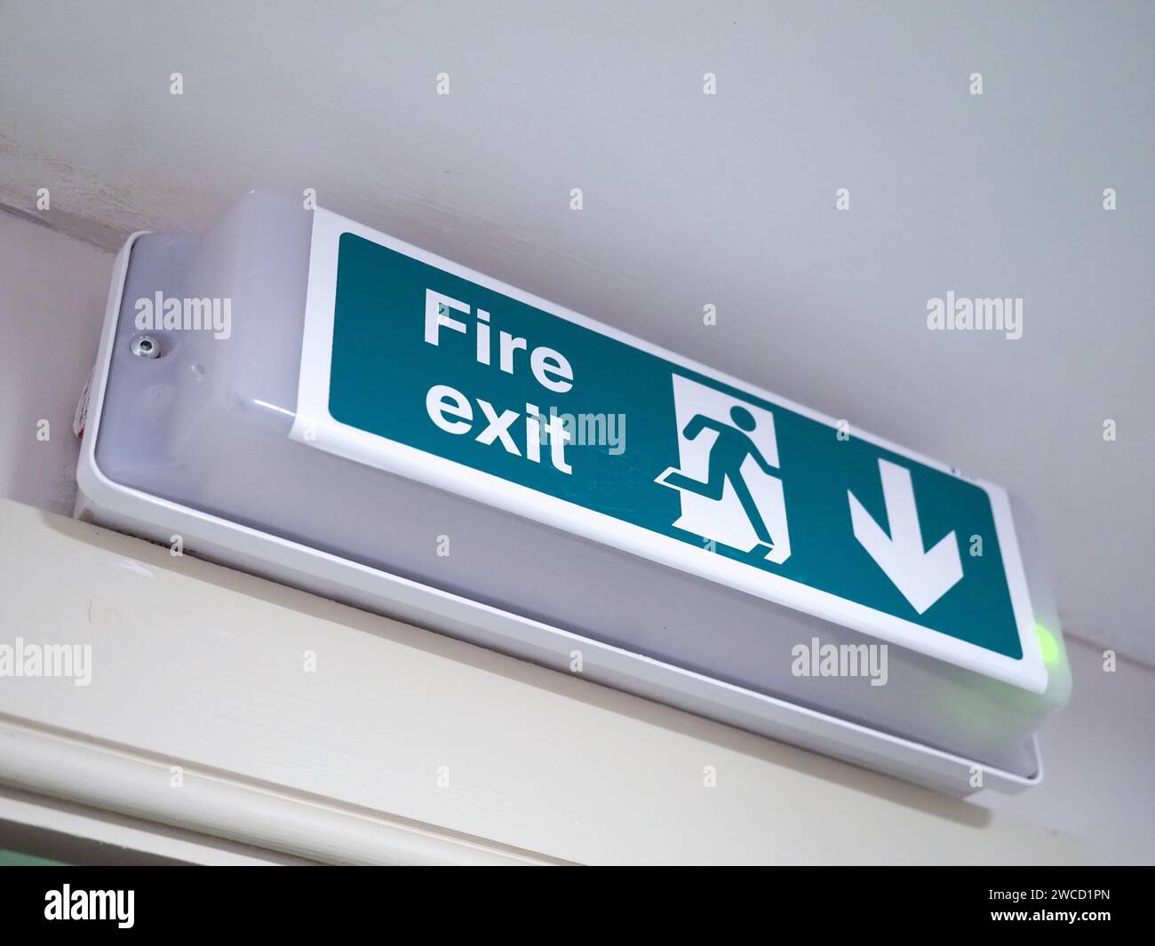Fire Exit Sign Above Green Wooden Door Stock Photo - Alamy