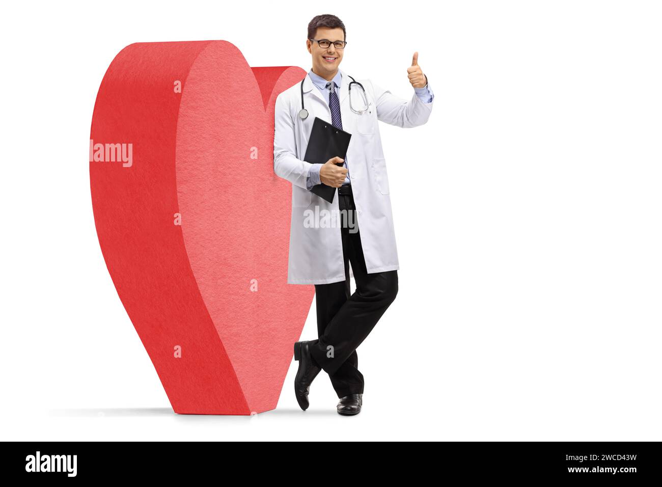 Full length portrait of a doctor cardiologist leaning on a heart and ...