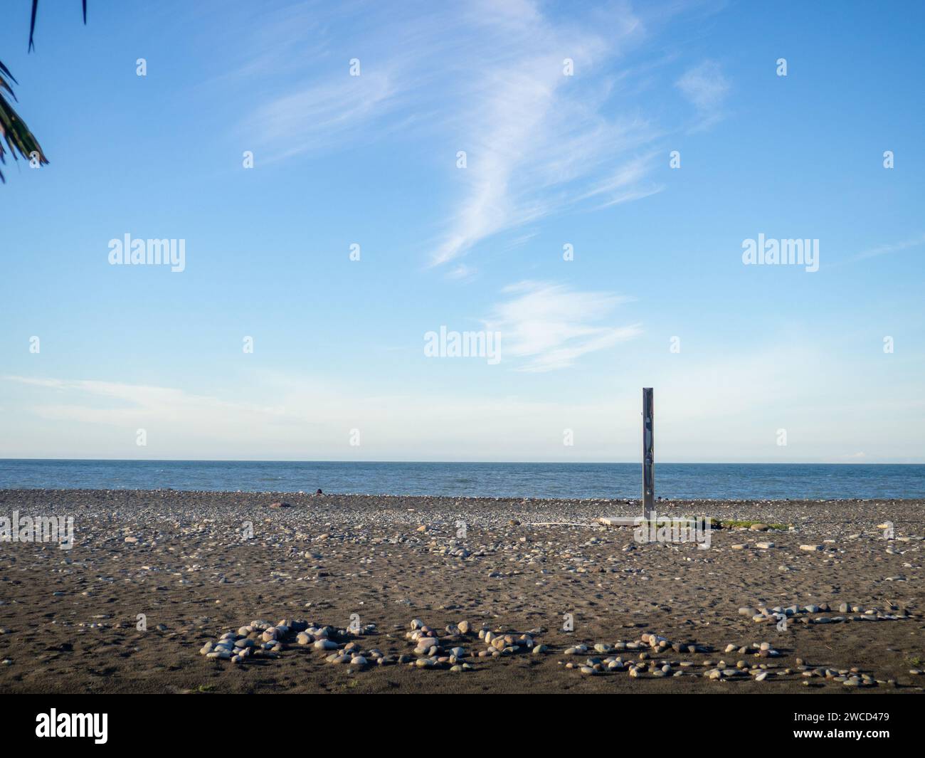 Deserted beach and black sea. Shower on the shore. Beach in winter. No ...