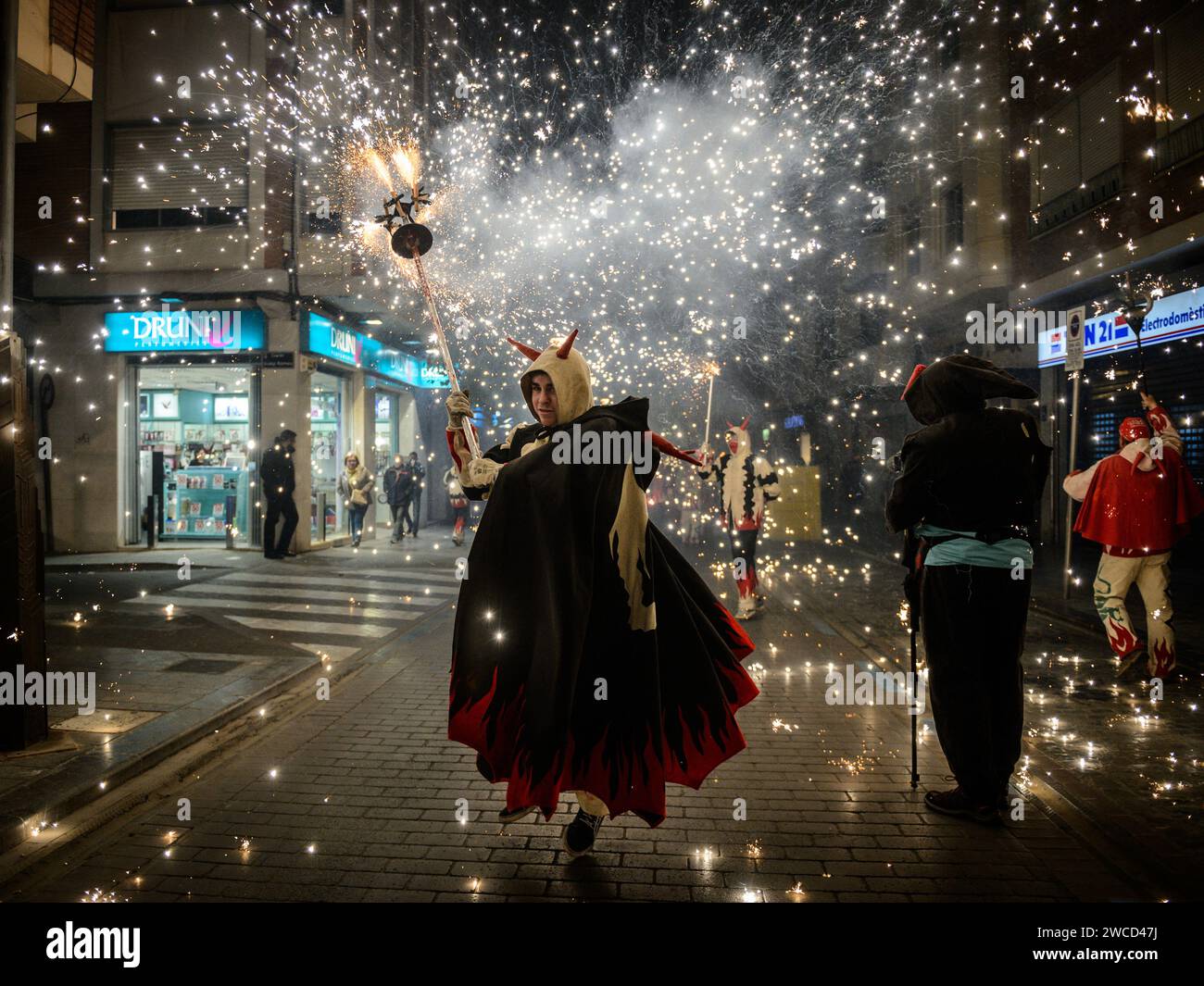 Correfocs (fire runners) through the streets of Sagunto in the ...
