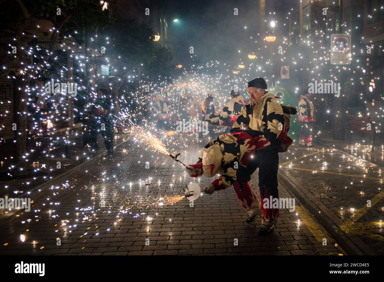 Correfocs (fire runners) through the streets of Sagunto in the ...