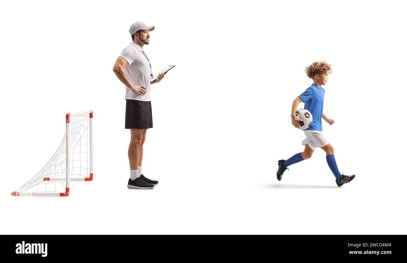 Full length profile shot of a coach and boy running and carrying a ...