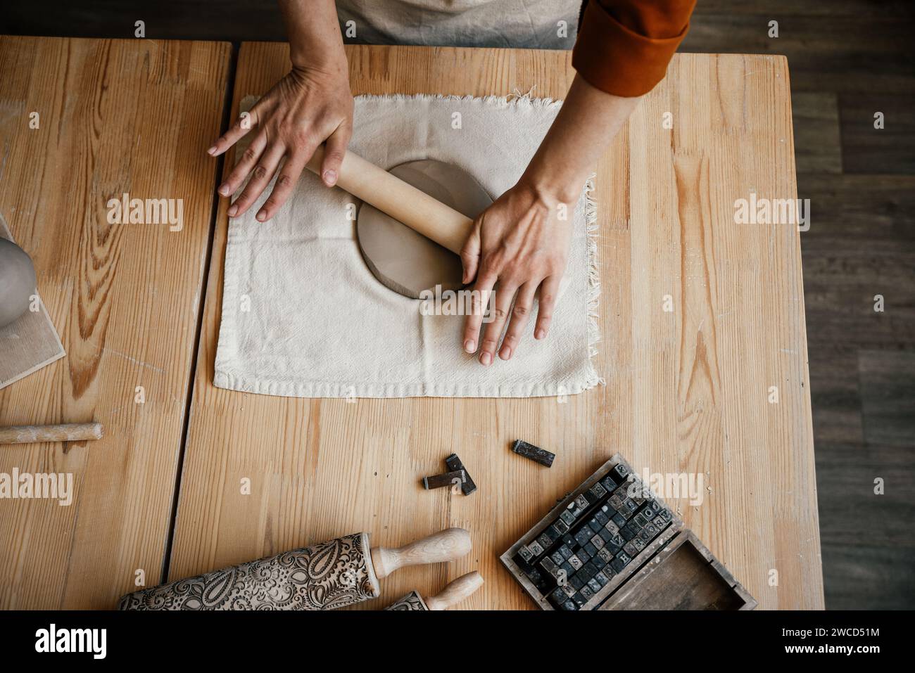 Female potter preparing clay for modelling on table, top view Stock ...