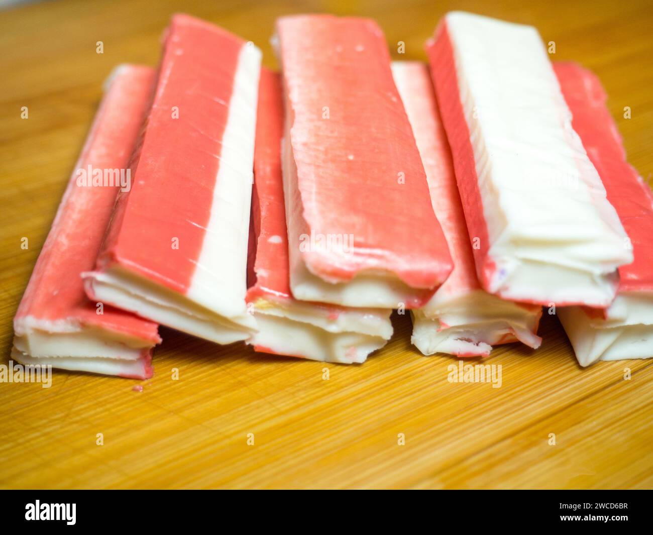 Crab sticks without packaging. Ingredient on cutting board. Fish salad ...