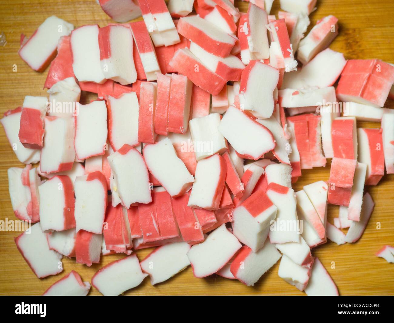 Crab sticks cut into pieces. Cutting with a knife. Ingredient on ...