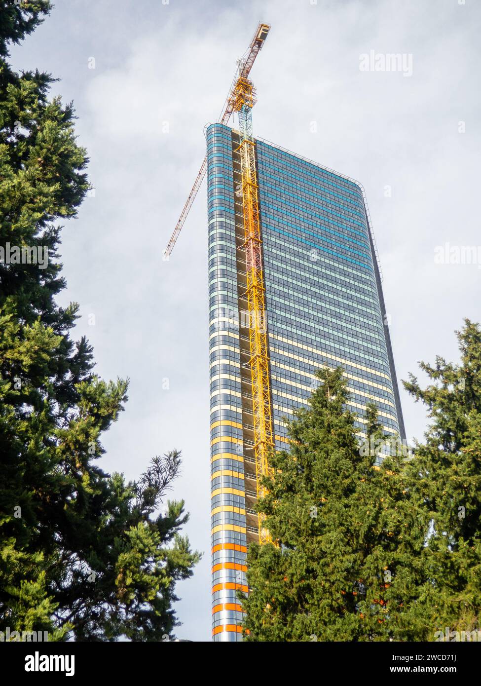 High-rise building under construction. New house with glass facade. The ...