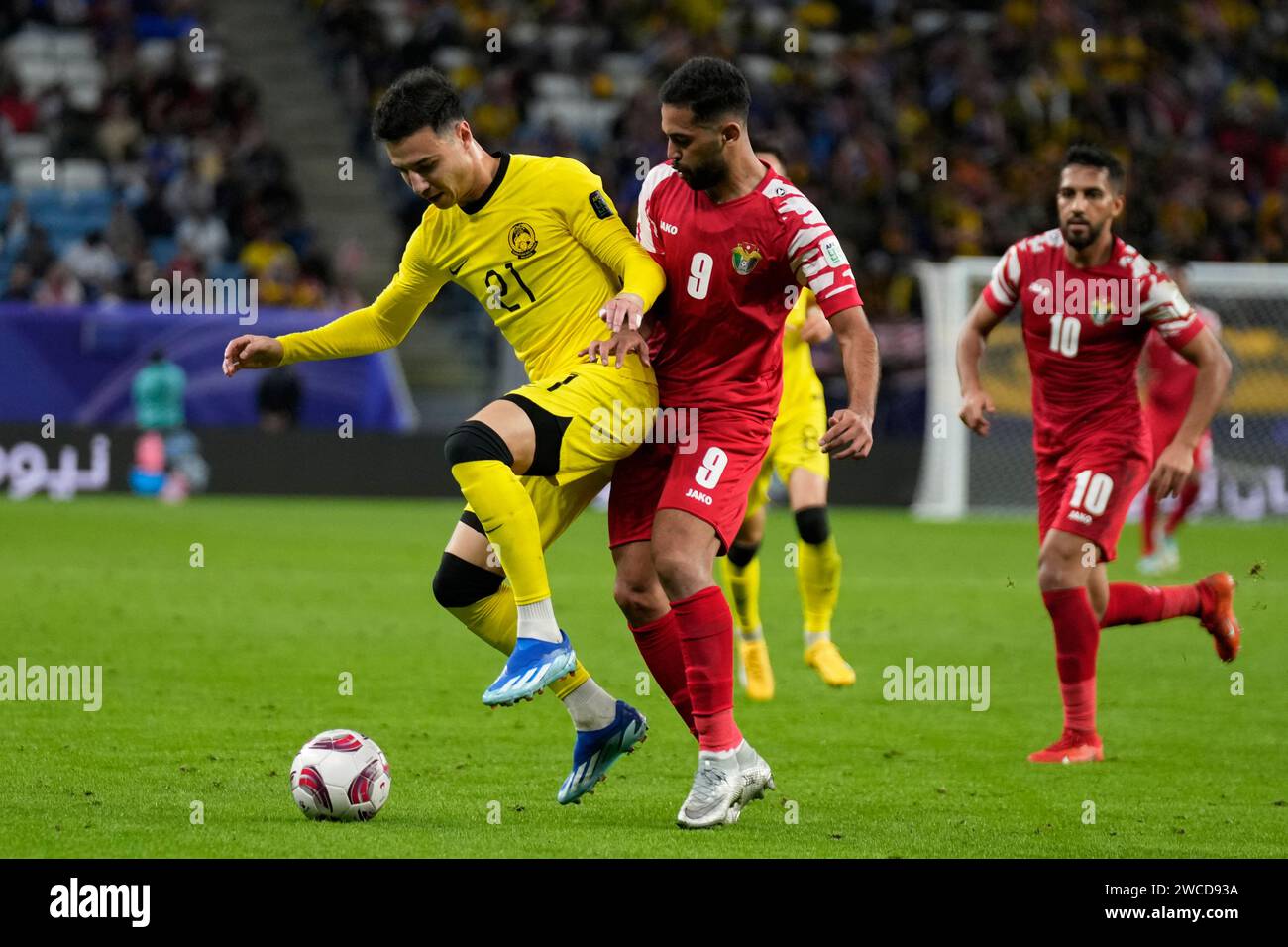 Malaysia's Dion Cools, left, tries to control the ball as Jordan's Ali ...
