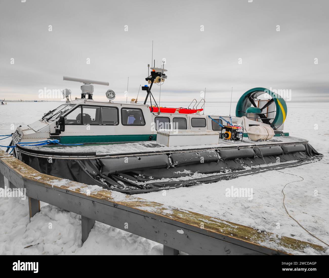 Coast and border guards hovercraft parked on an icy shore of frozen ...