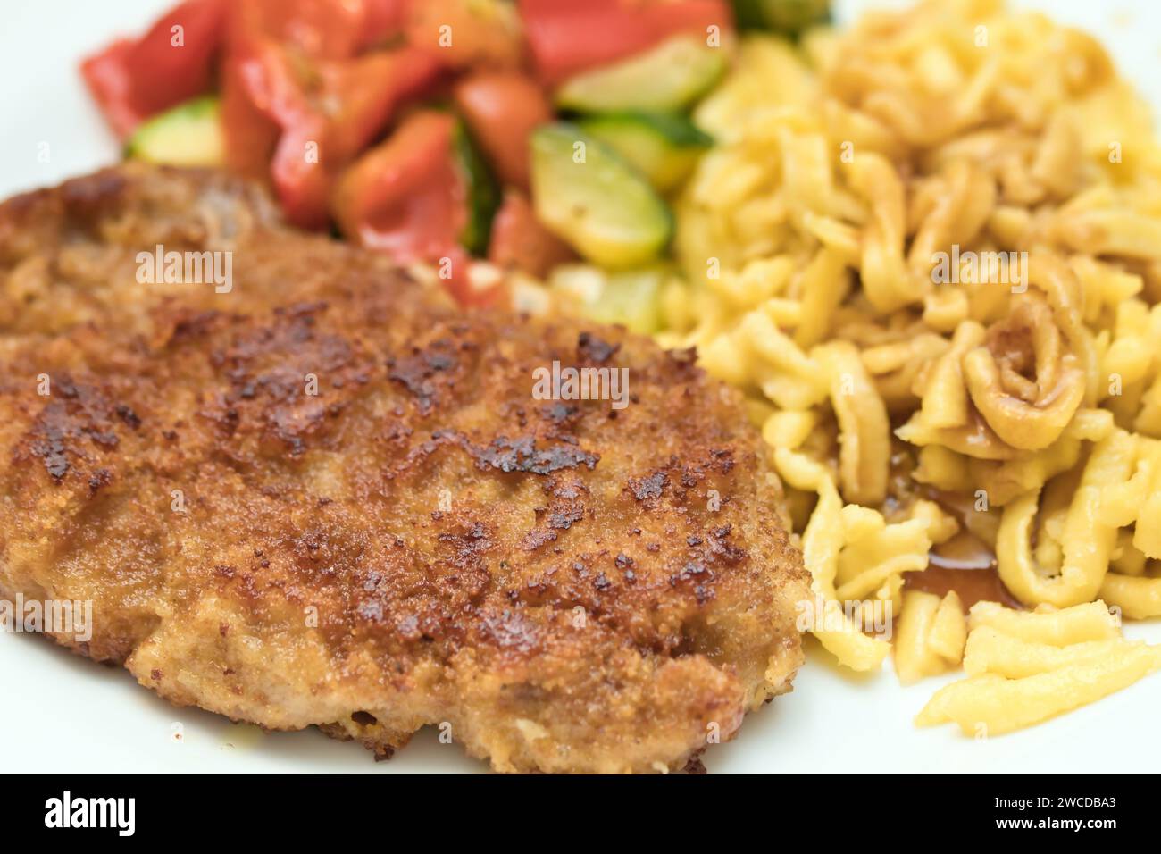 Schnitzel with spaetzle and vegetables Stock Photo - Alamy