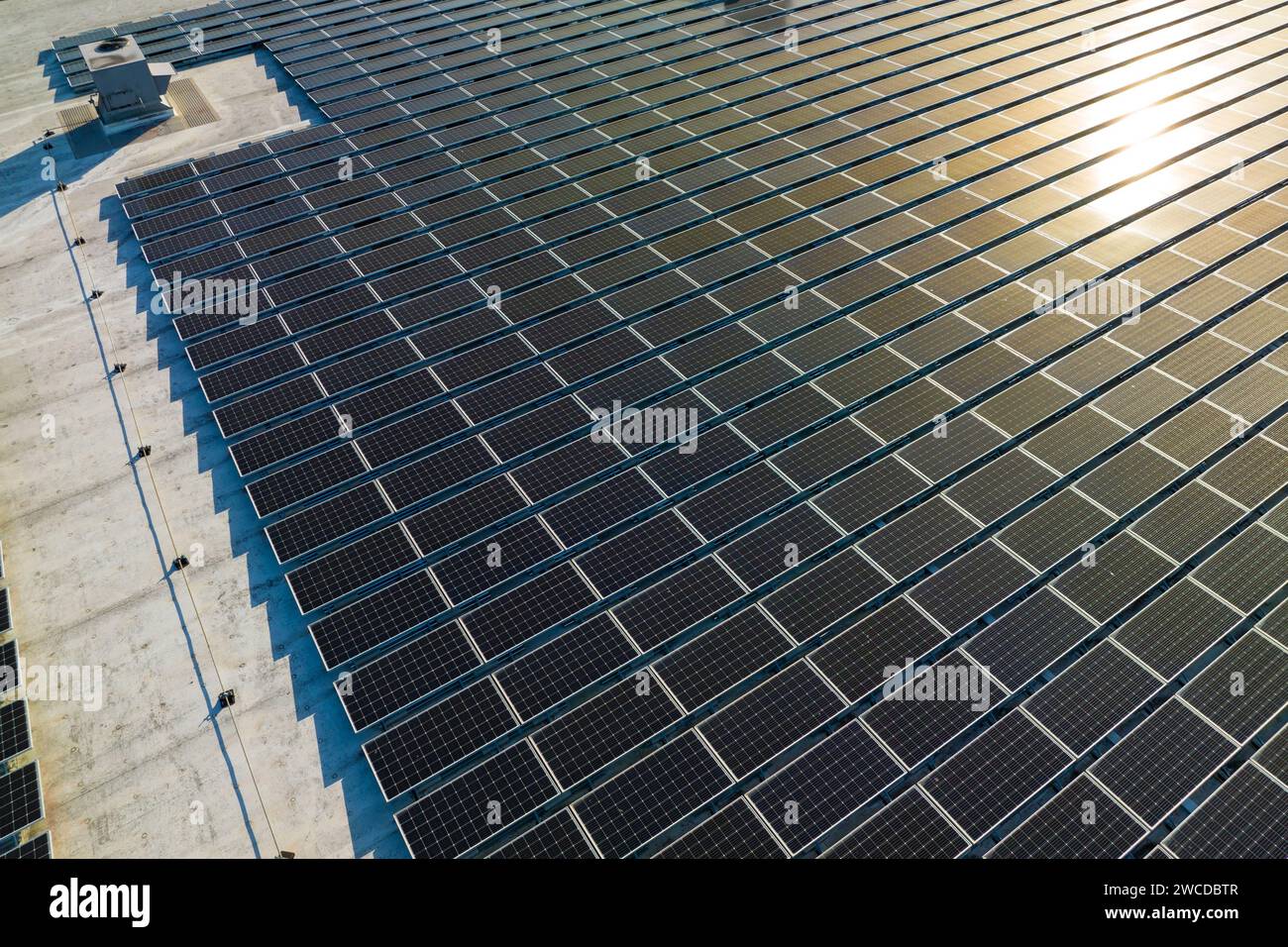 Aerial view of solar power plant with blue photovoltaic panels mounted ...