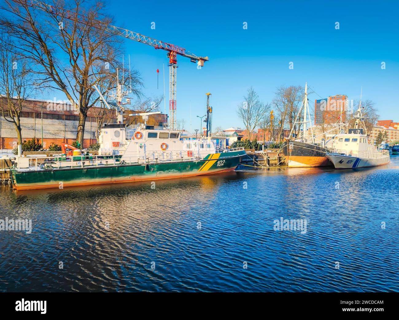 Old fisherman boat standing in the harbor in Dane river, Klaipeda ...