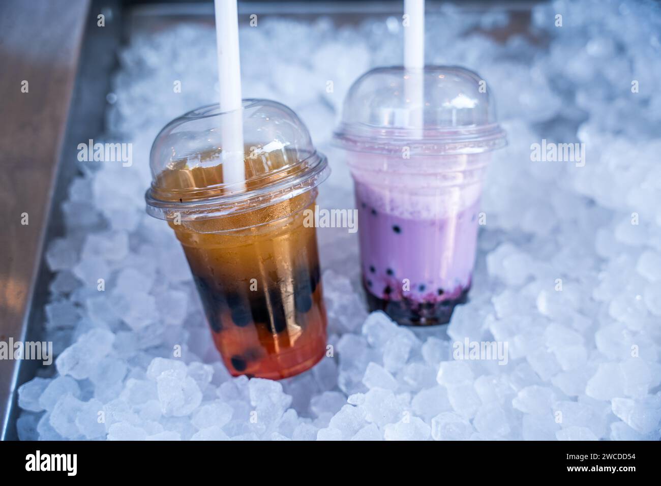 Two refreshing summer beverages - a cold iced tea and a berry smoothie ...