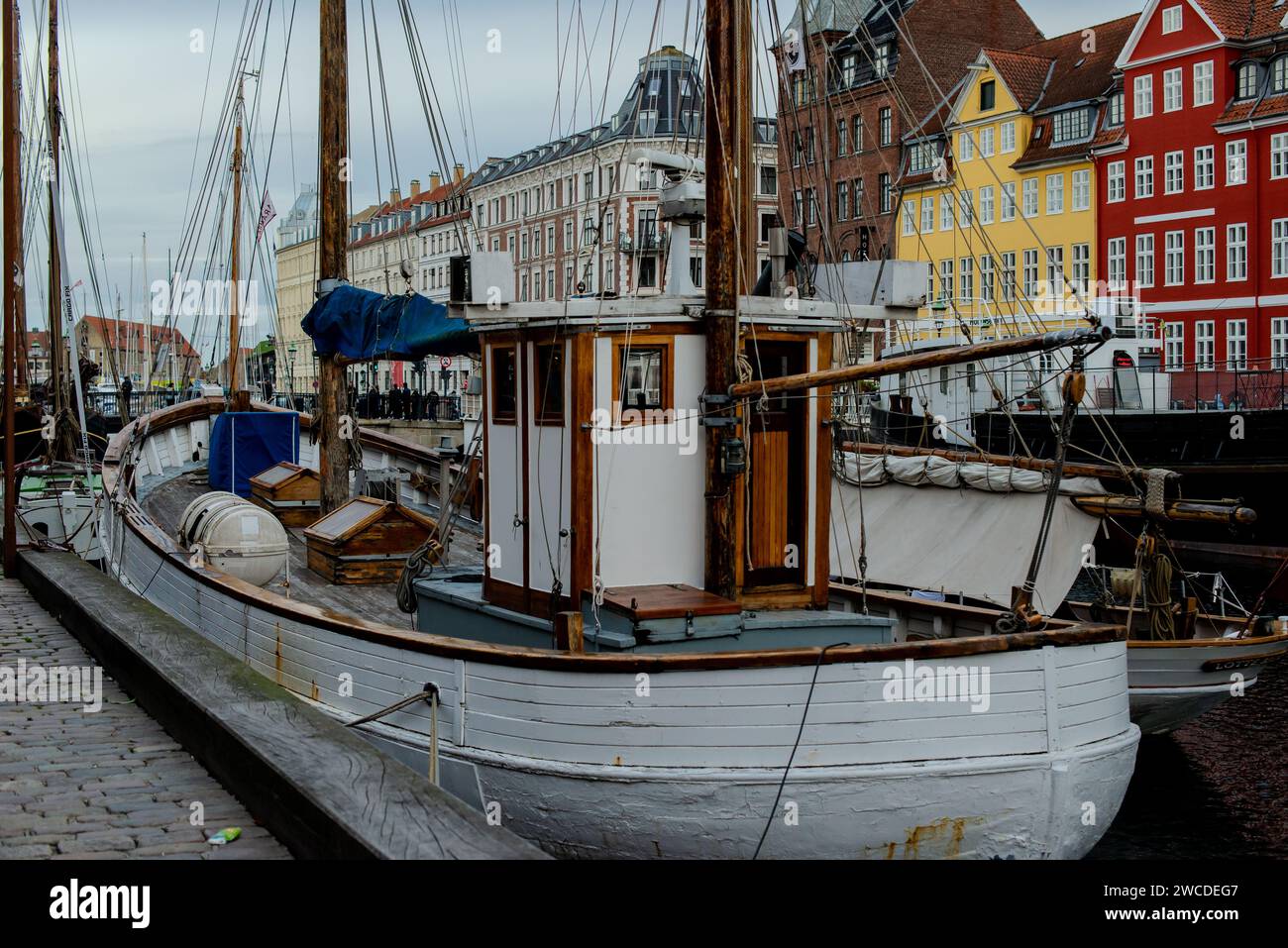 A pristine white boat rests gracefully alongside a charming backdrop of ...